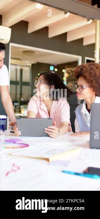 Vertical video of happy diverse male and female colleagues in ...