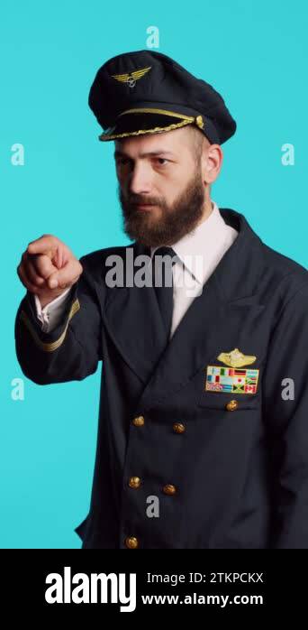 Vertical video: Plane captain in aviation uniform pointing at camera ...