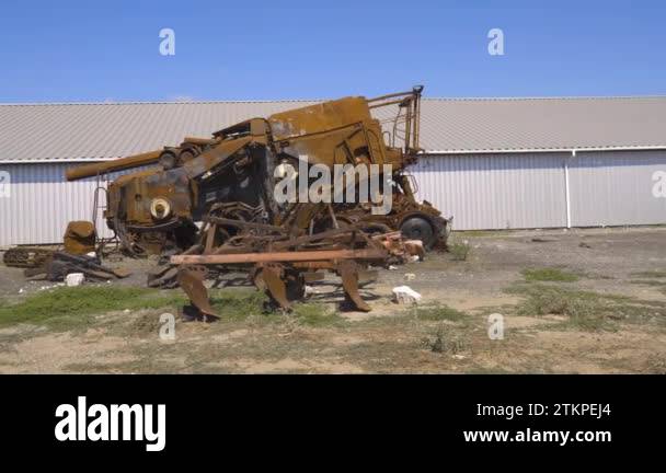 Damaged agricultural machinery destroyed by artillery fire (panorama ...