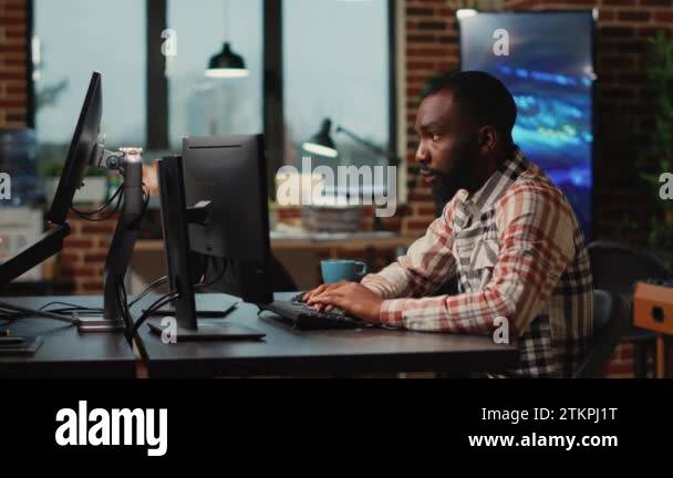 Team of professional developers working on software development with manufacturing interface ...