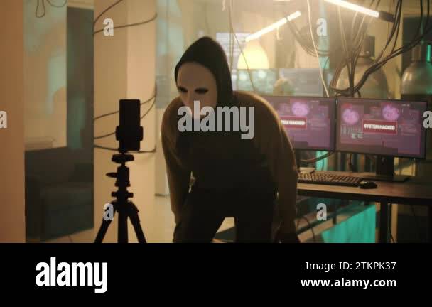 Male spy with anonoymous mask filming live threat video, asking for ...