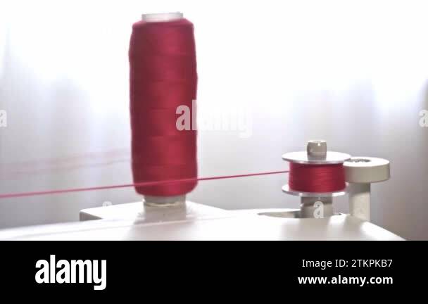 The process of winding thread on the bobbin of a modern sewing machine ...