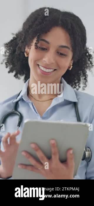 Tablet, smile and woman doctor reading information in hospital for ...