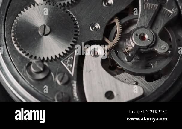 The mechanism of vintage stopwatch rotates close-up. Round clock watch ...