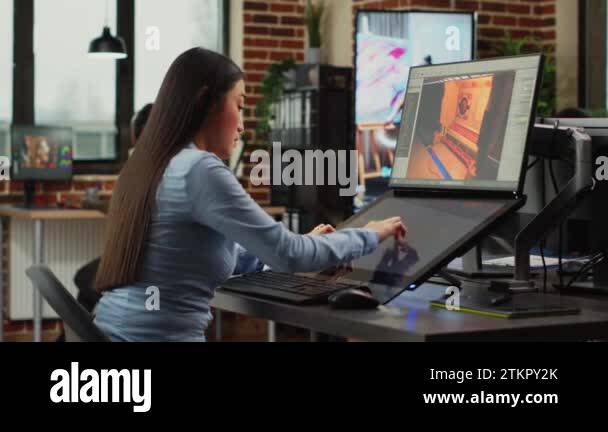 Asian game developer working in production department to create ...