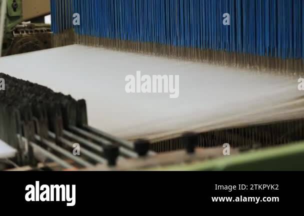 weaving loom. Textile factory equipment. Close-up. Automated weaving ...