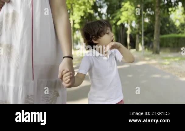 Distracted Boy Picking Nose While Stroll Amidst Nature's Beauty at ...