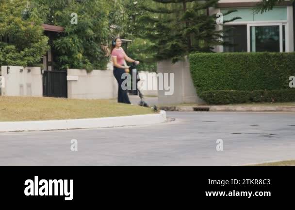 Young woman happy smile girl go green asia people ride EV bike push ...