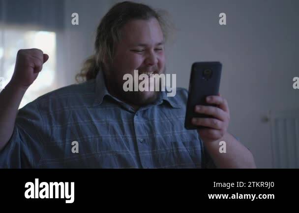 One excited fat man celebrates success in front of computer. close up ...