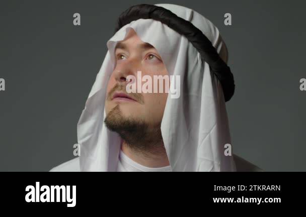 Portrait close up of successful arab man in traditional outfit, wearing ...