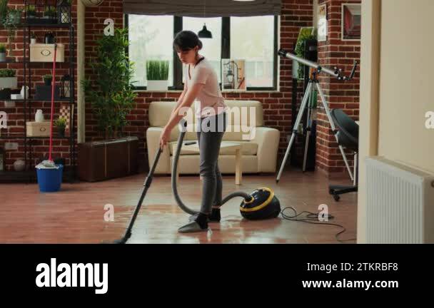 Modern housewife sweeping dust with mop in apartment, mopping floors ...