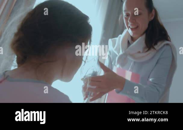 Caring mother giving to little daughter respiratory mask to treat ...