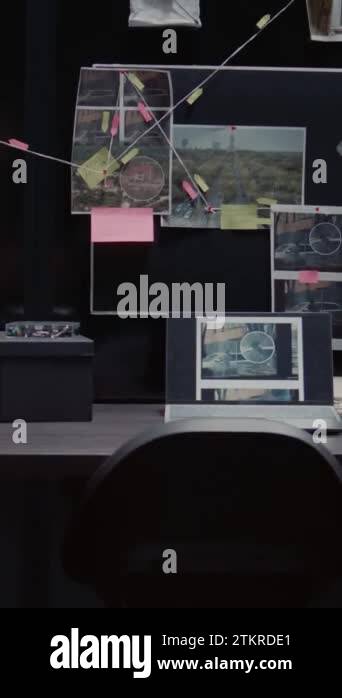 Vertical video: Private inspector examining clues and records ...