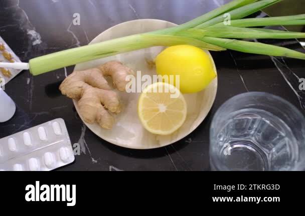 Ginger, lemon, onion and different drugs on table on background sick ...