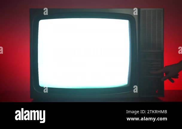 Retro TV on dark red illuminated background, antique television with ...