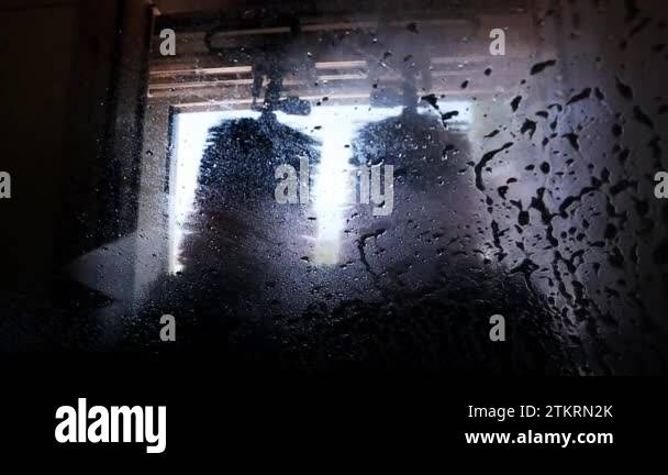Washing the car in an automatic wash. View of the automobile from ...