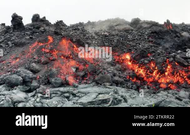 Epic shot on smartphone camera os red hot lava flowing and freezing ...