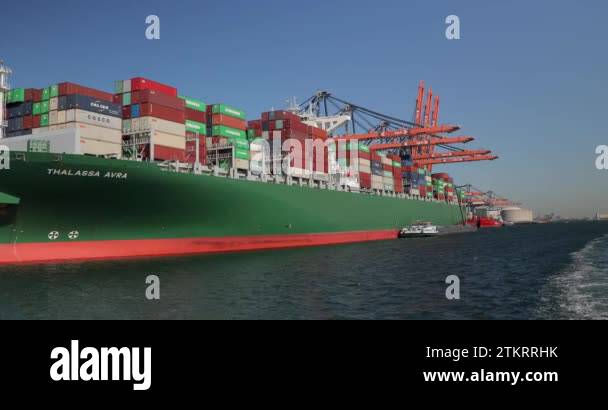 Rotterdam, The Netherlands - Circa 2019: Containers being loaded on a huge cargo ship in the ...