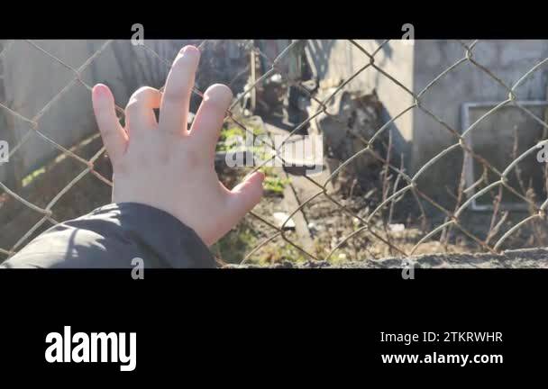 iron grate. steel mesh. the hand is holding the grate. a man's hand ...