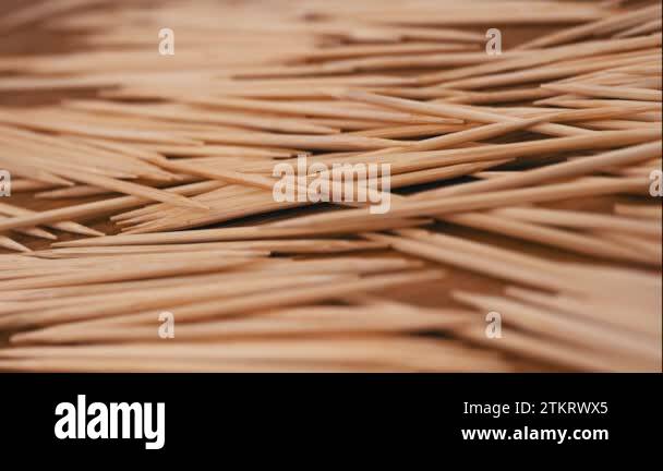 Lots of Scattered Brown Toothpicks Rotate on a Wooden Background. Close ...