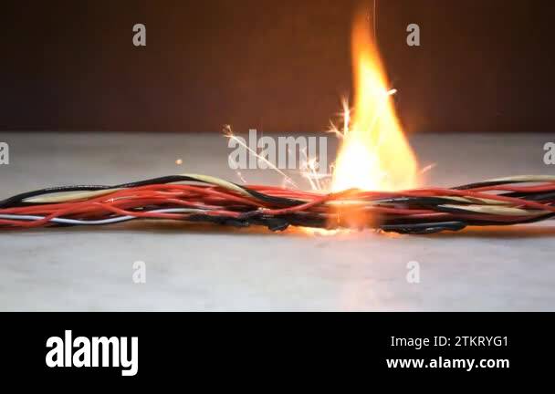 The wiring is lit and sparkles on a dark background. A short circuit in ...