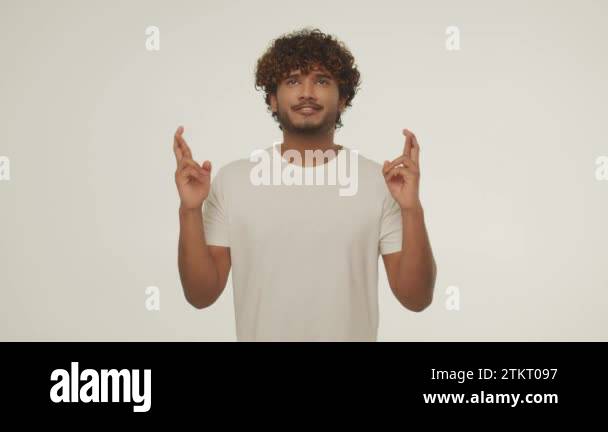 Excited young man showing hope gesture. Indoor footage of handsome guy ...