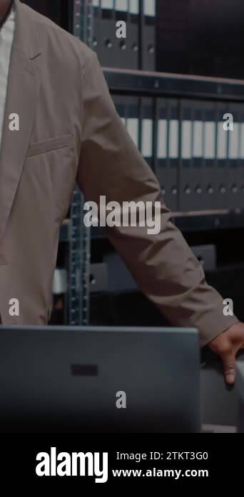 Vertical video: Inspector searching for forensic evidence in case file ...