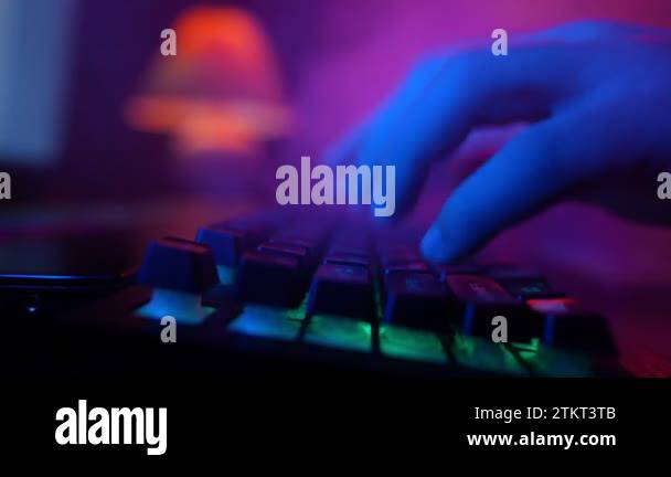 Male Hands Rapidly Typing On A Computer Keyboard In Smoky Neon Lighting Unrecognizable Guy