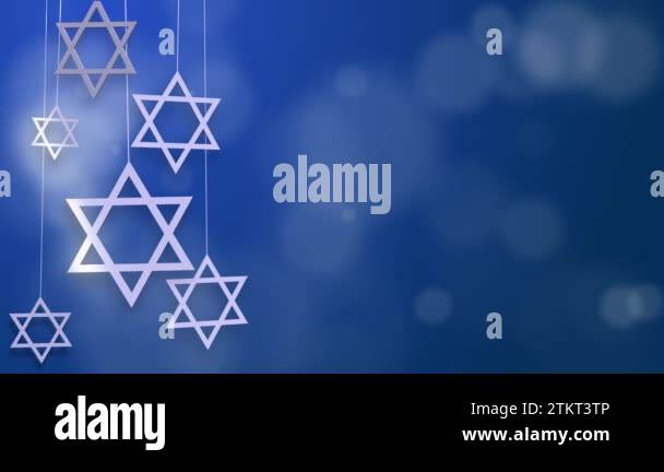 White Jewish Stars of David spin on thin threads. Blue abstract ...
