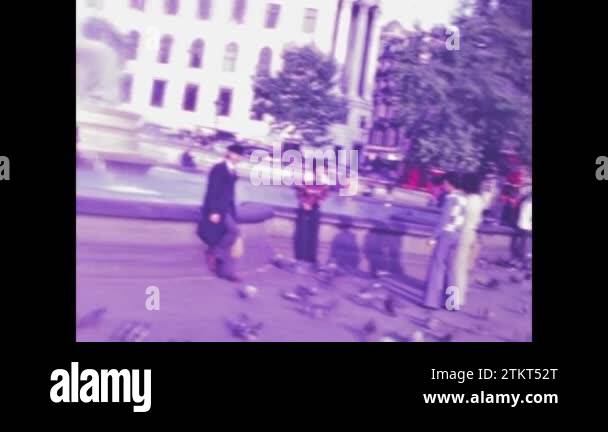 LONDON, UK 9 JUNE 1975: A nostalgic look at tourists interacting with ...