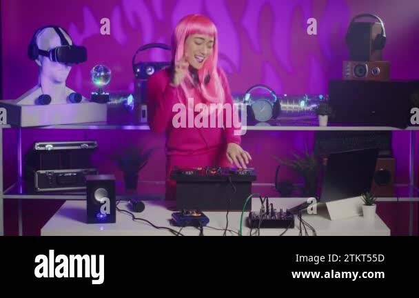 Cheerful performer standing at dj turntables mixing sounds during ...