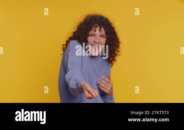 Mime curly haired woman pulling an imaginary unreal invisible rope ...