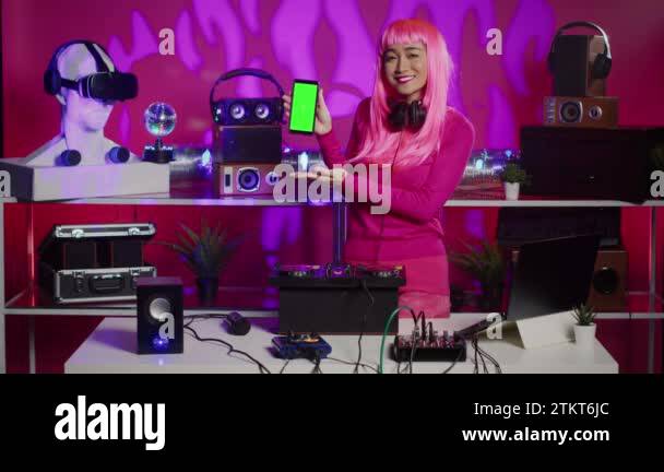 Cheerful artist presenting green screen mock up smartphone with ...