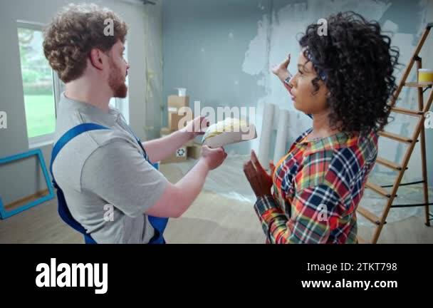 Customer is an African American woman and white male foreman choosing ...