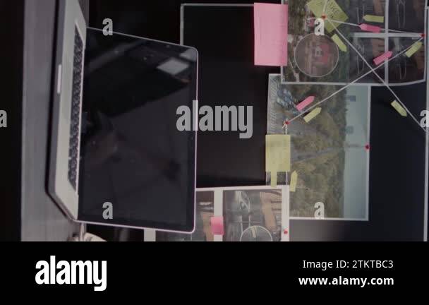 Vertical video: Criminal evidence board in private investigation office ...