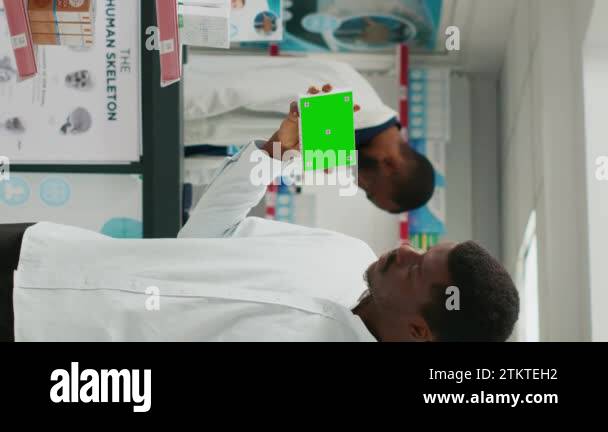 Vertical video: Young adult holding pack of drugs with greenscreen in ...