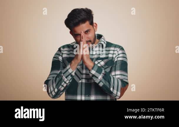 Villain idea. Sneaky young indian man conspiring scheming, thinking ...