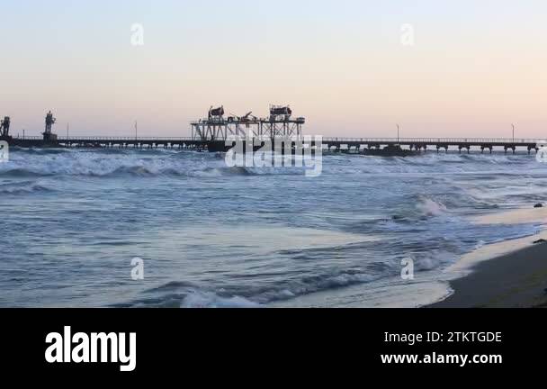 beach waves with oil platform in ocean. Caspian sea offshore oil rig ...