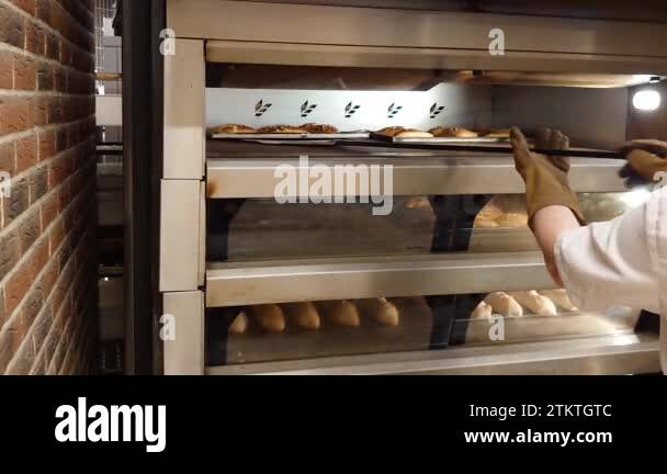 Craft mini-bakery producing French pastries. The baker takes freshly ...