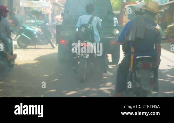 Lombok, Indonesia - August 23, 2023: Pollution of Motorbikes gas along ...