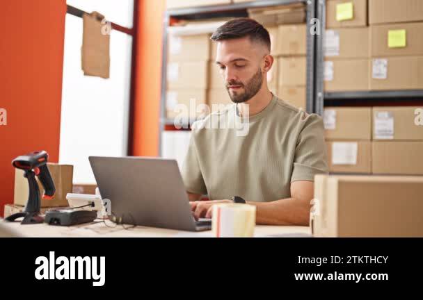 Young hispanic man ecommerce business using laptop looking watch ...