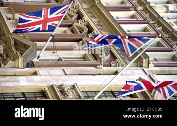 Close vertical view of flags of the United Kingdom located on facade of ...