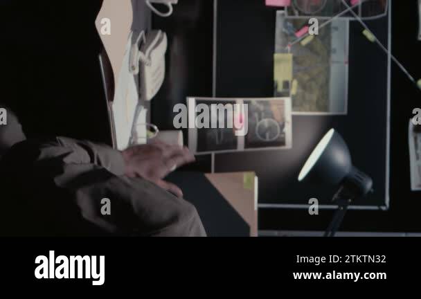 Vertical video: African american agents examining surveillance photos ...