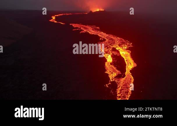 Volcano eruption at night, Red burning lava erupts from crater in ...