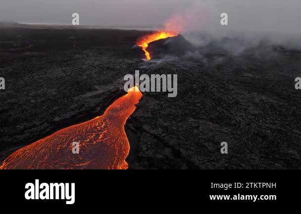 Volcano eruption at night, Red burning lava erupts from crater in ...