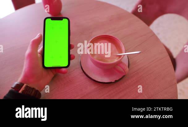 Chroma key of smartphone in a male hand, using and scrolling a mobile ...