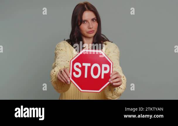 Serious pretty woman say No, hold inscription text red No stop danger ...