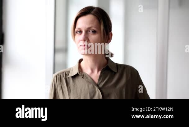 Smart woman tapping her fingers on forehead and showing how to work 4k ...