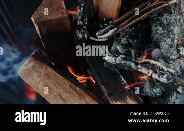 Firewood burning on barbecue grill. Firewood and coals burning on BBQ ...