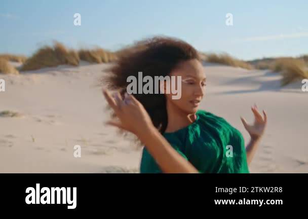 African american expressive girl performing contemporary dance at sand ...